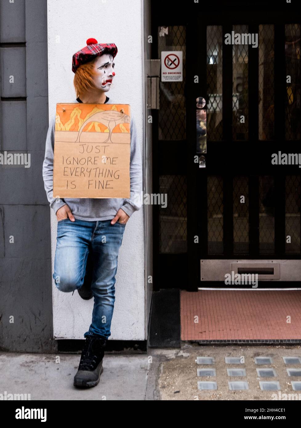 Clown takes a break during a climate change protest march Stock Photo ...