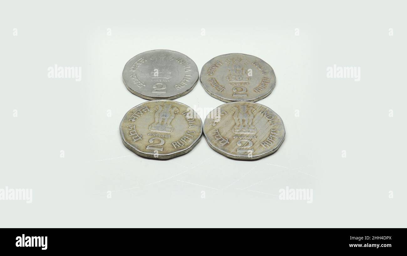 Indian Rupee Coins. old four two rupee coins. On a white background ...