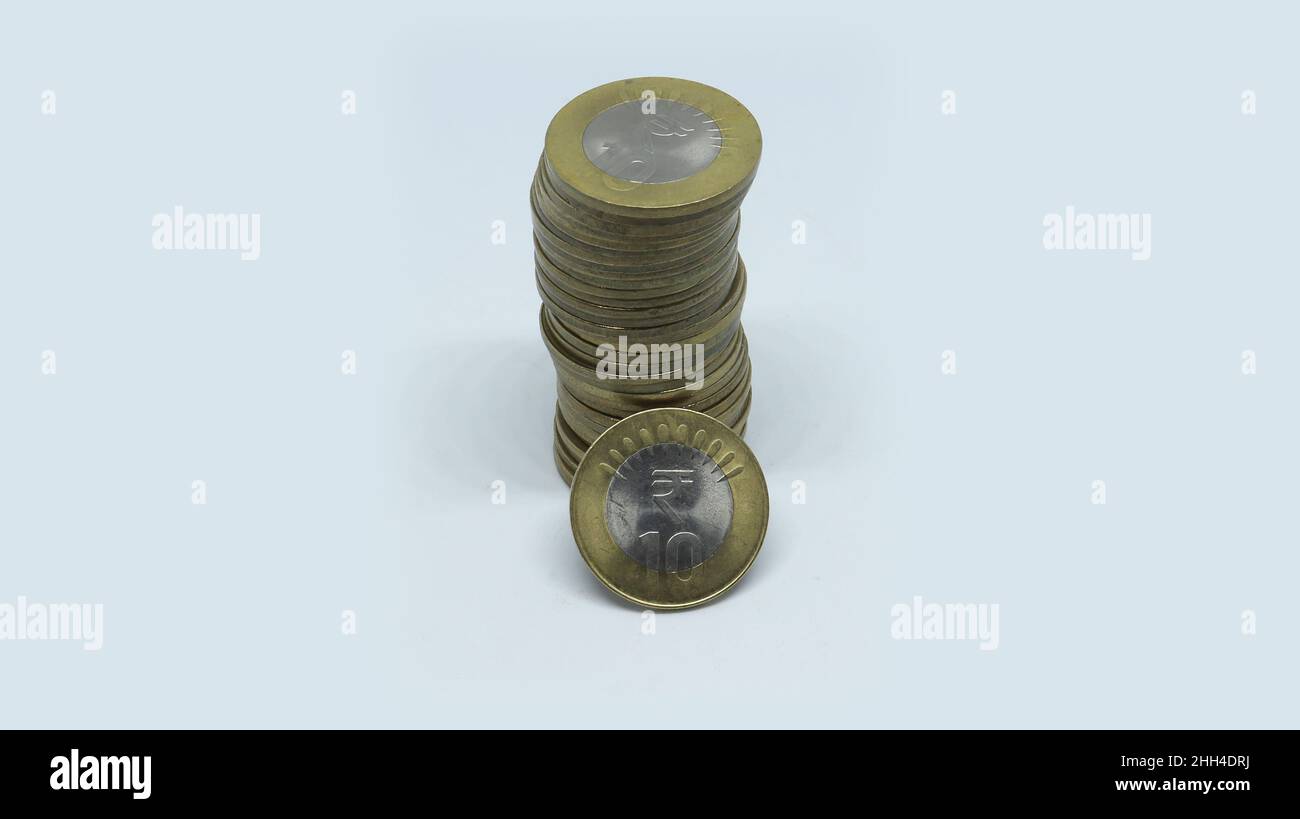 Indian Rupee Coins. Ten rupees coins stacked vertically. On a white ...