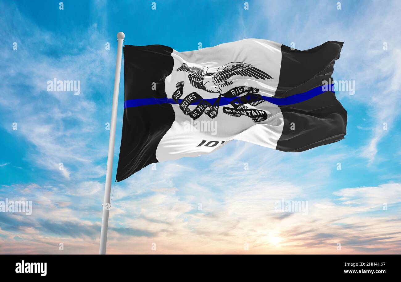 blue line flag of Iowa state, Usa at cloudy sky background on sunset ...