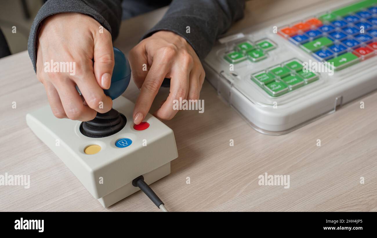 Woman with cerebral palsy works on a specialized computer mouse Stock ...