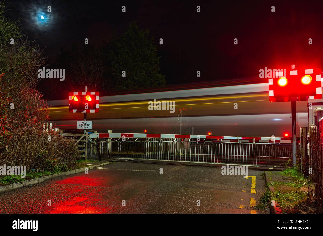 Railroad crossing during a winter afternoon in a city in England ...