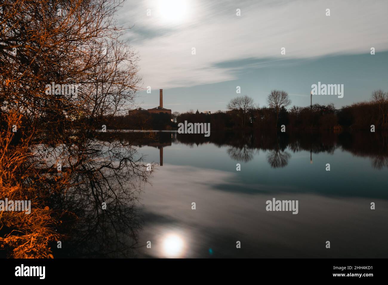 Full moon evening by a lake in a town in England Stock Photo - Alamy