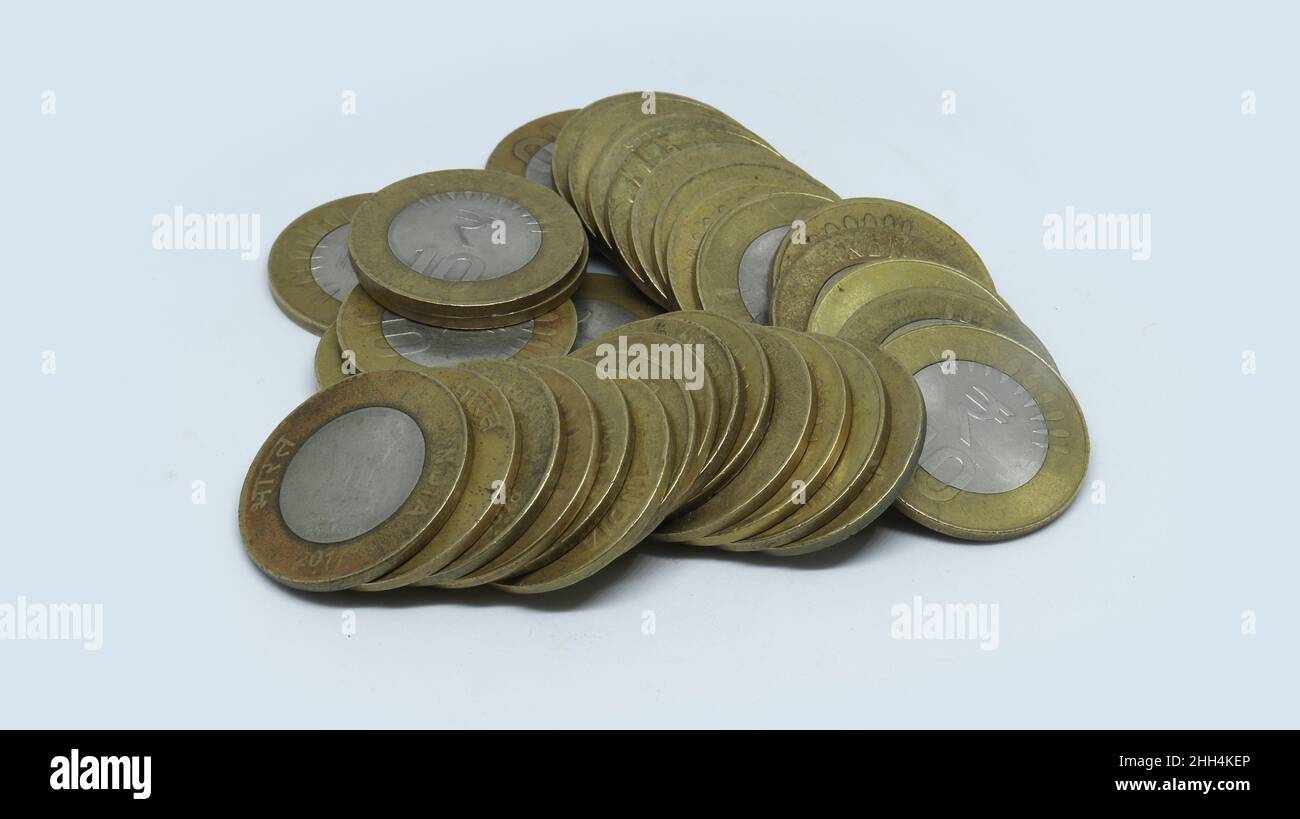 Pile of Indian Rupees Coins. Ten rupees coins. On a white background ...