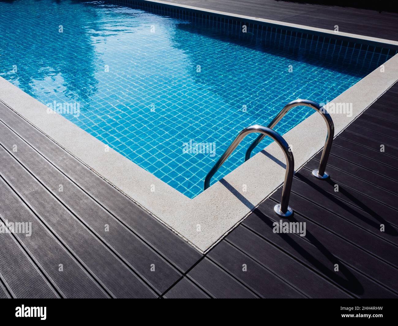 Stone edge frame on the square swimming pool with clean clear water ...