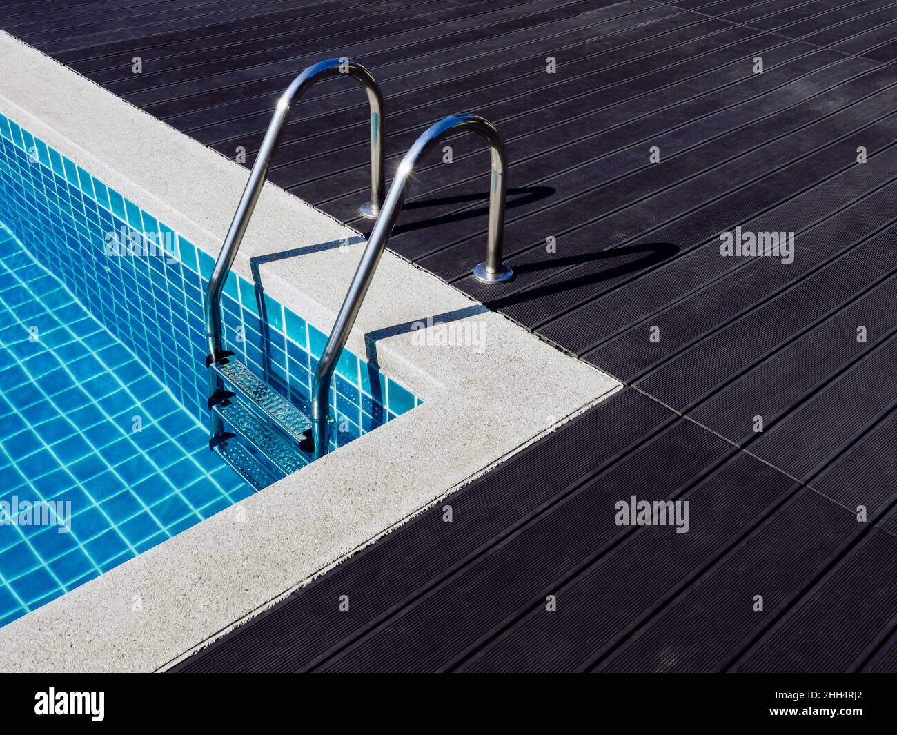 Stone edge frame on the square swimming pool with clean clear water ...