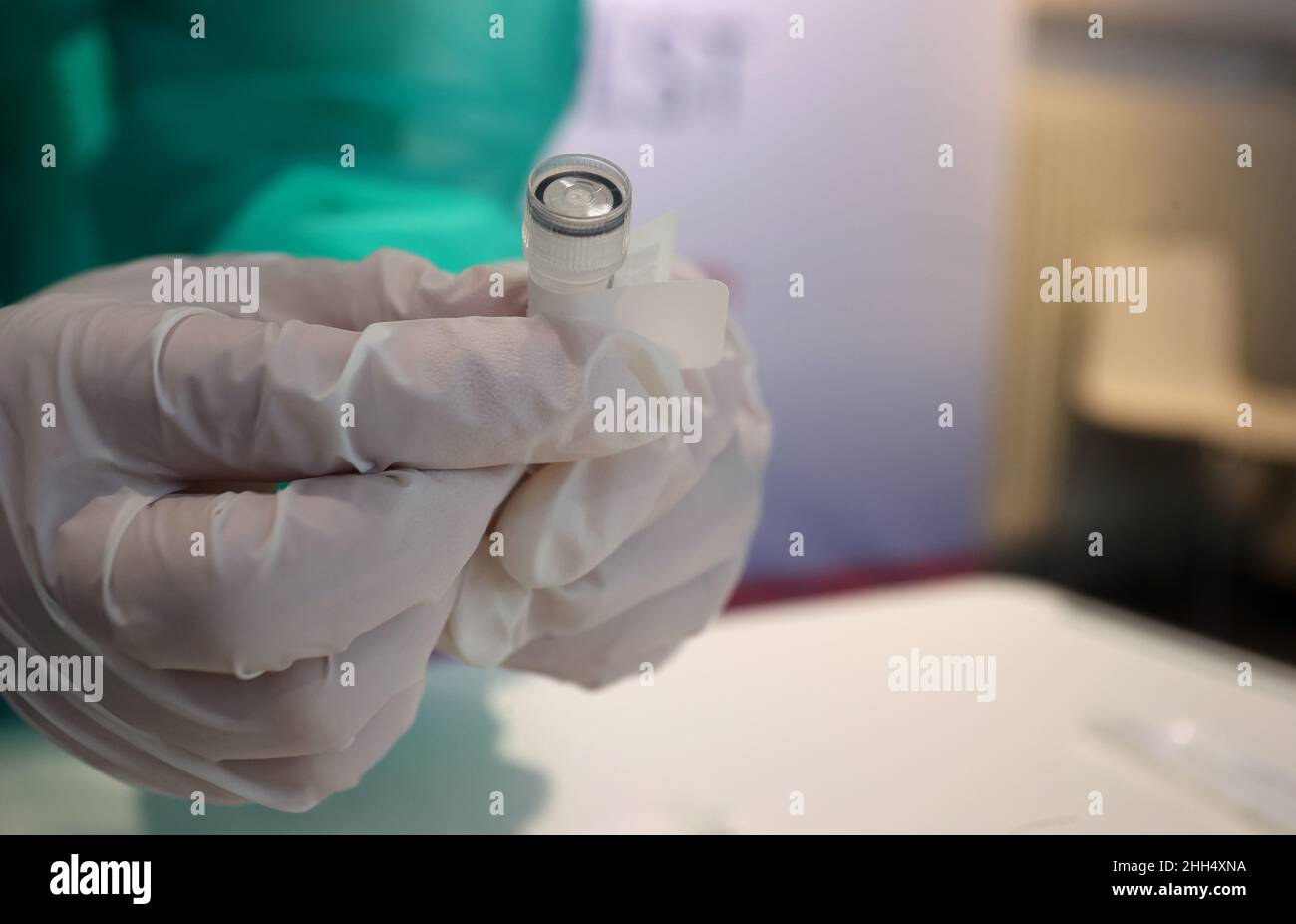 23 January 2022, Bavaria, Munich: A medical assistant holds a tube ...