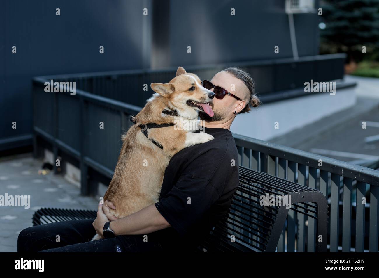 Attractive man hugging pretty dog. Concept of care, education ...