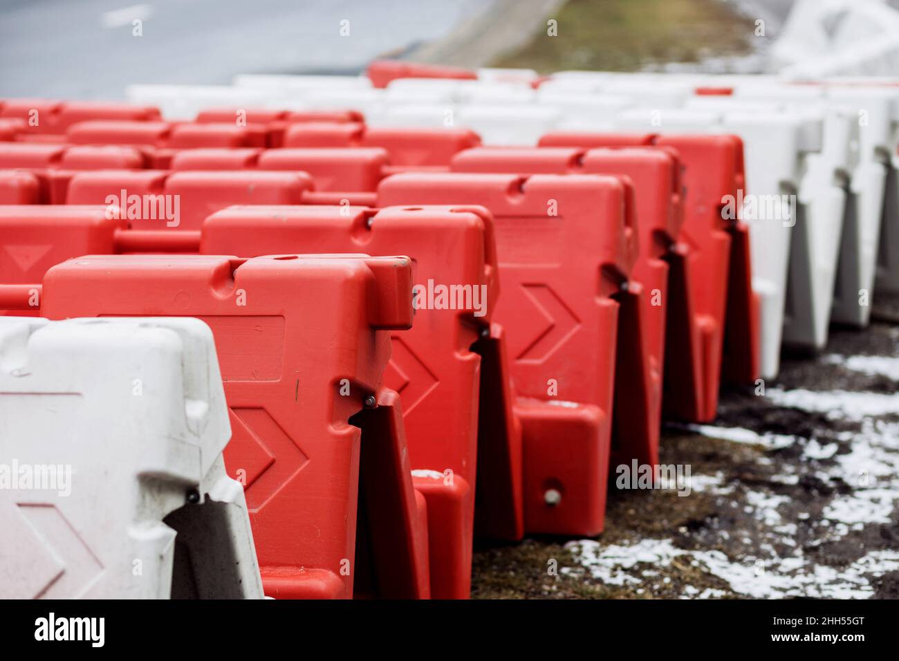 red and white plastic barriers in a row. danger zone, the passage is ...