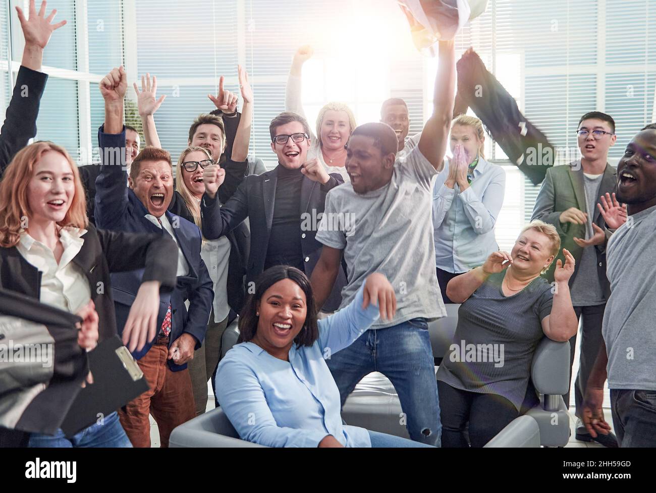 Happy multi ethnic co-workers celebrating a victory in the office Stock ...