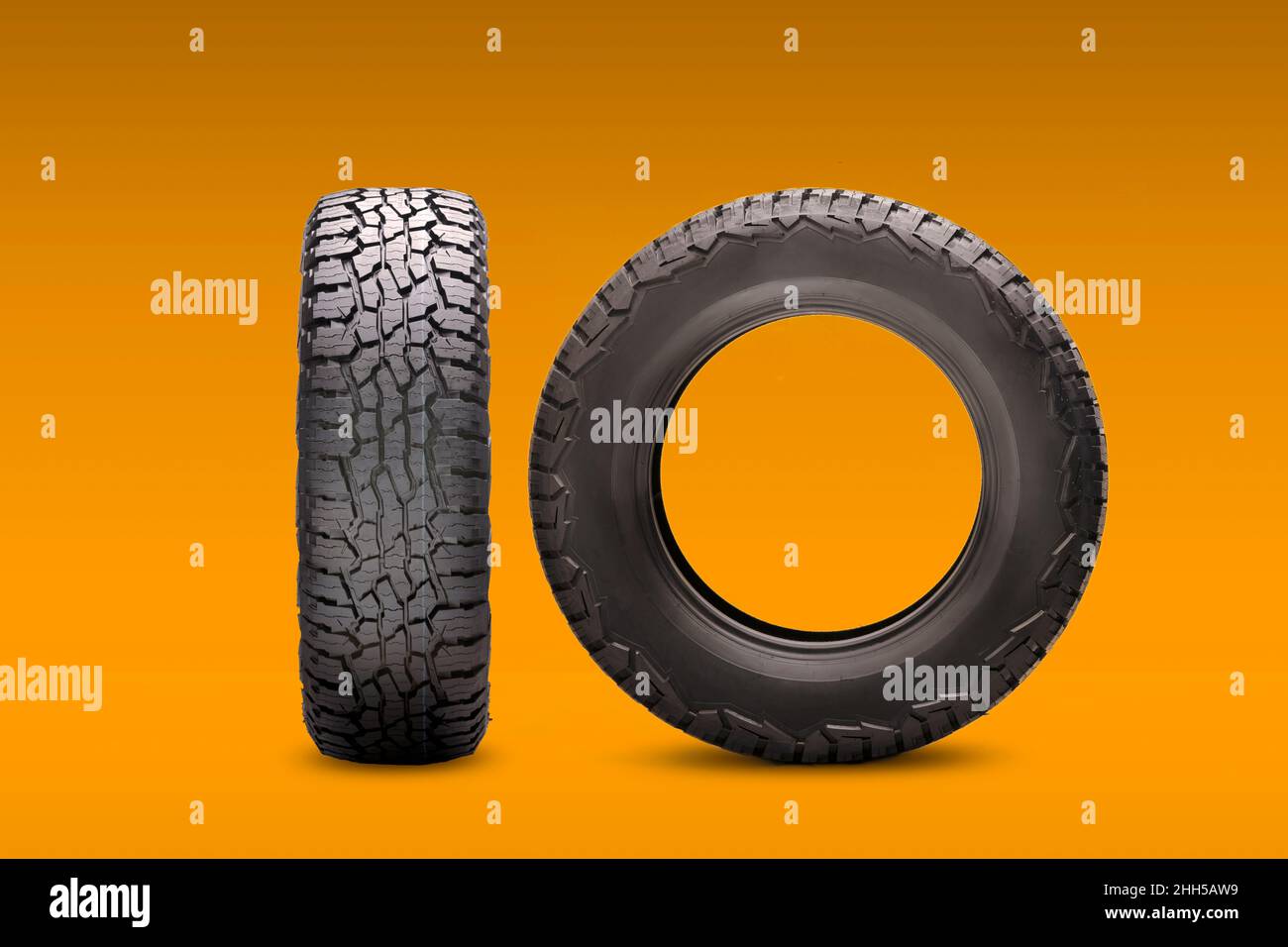 new all-season at tires on an orange background side and front view ...