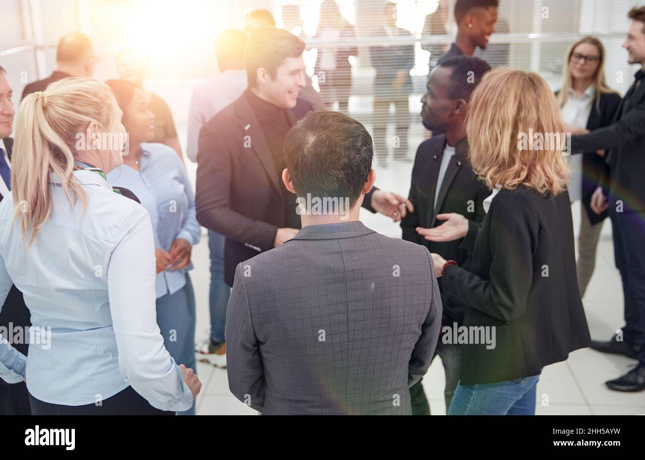 employees discussing work issues standing in the office . concept of ...