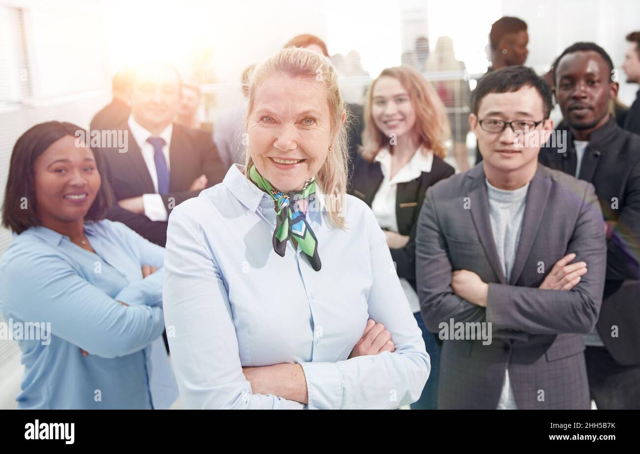 Multi ethnic business people with arms crossed standing near the window in conference room Stock ...