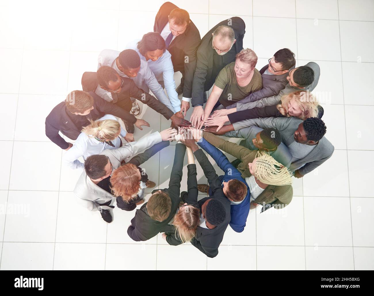 top view. group of diverse business people joining their palms together. concept of teamwork ...