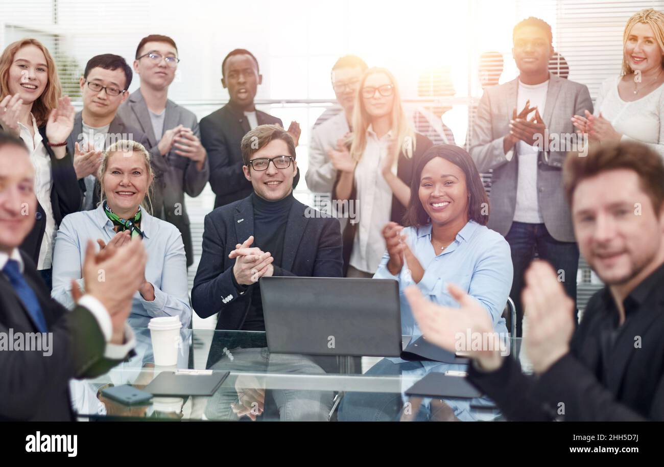 multinational working group celebrating together near the desktop ...