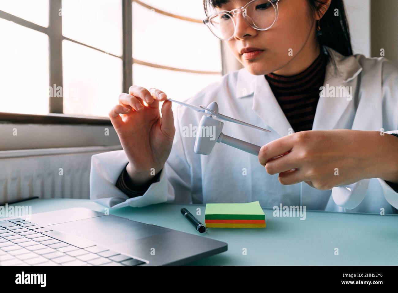 Young scientist examining wind turbine model in laboratory Stock Photo ...