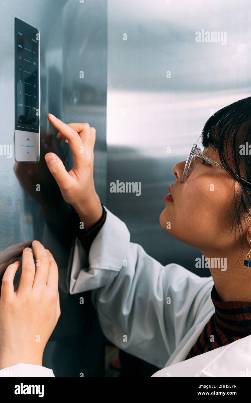 Young scientist using control panel Stock Photo - Alamy