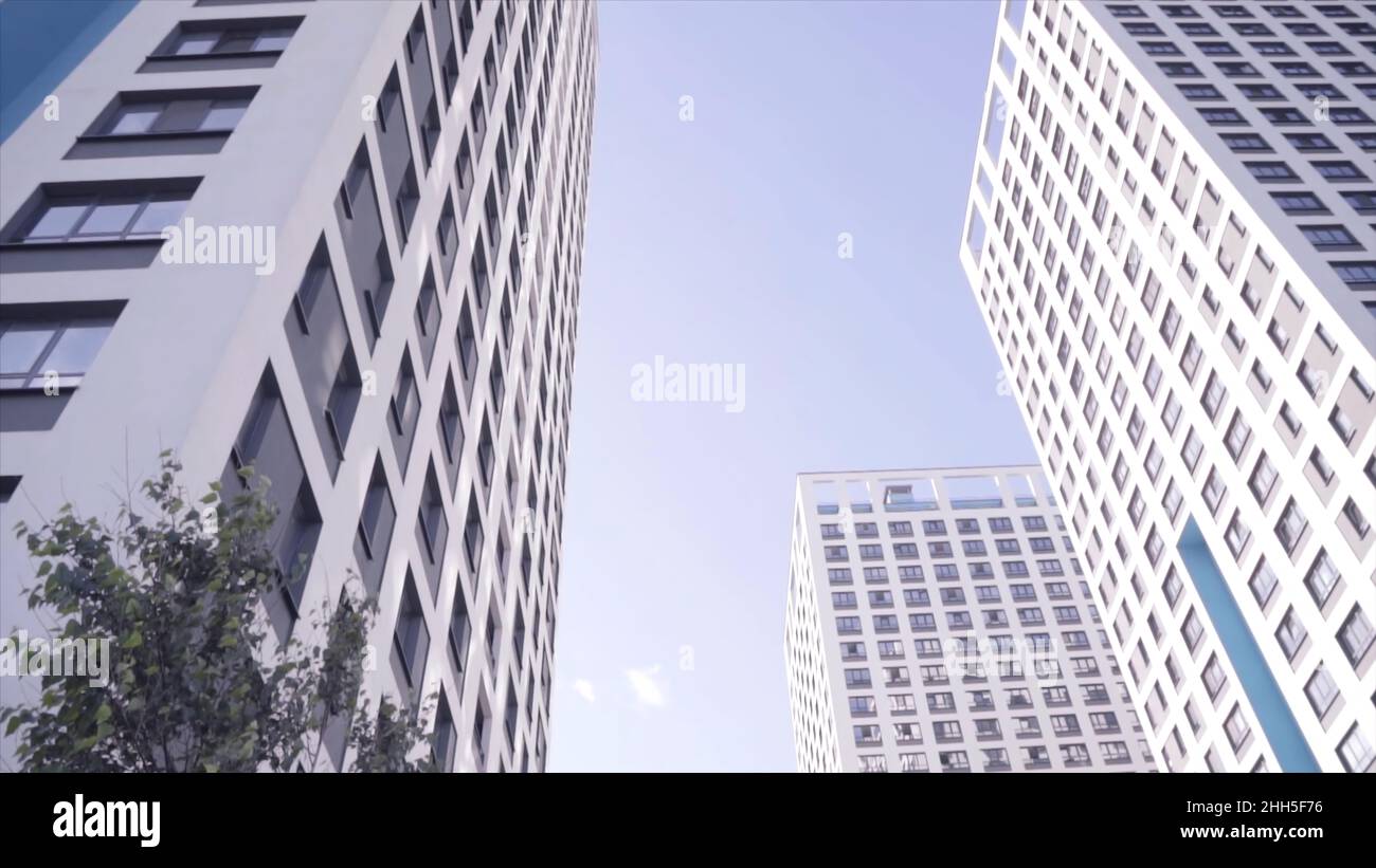 Bottom view of residential buildings with blue sky. Frame. Bottom view ...
