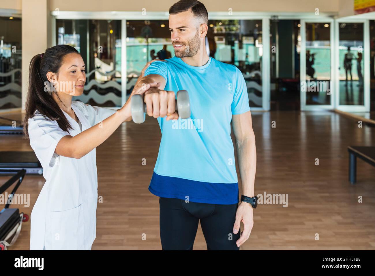 Female instructor guiding athlete hi-res stock photography and images ...