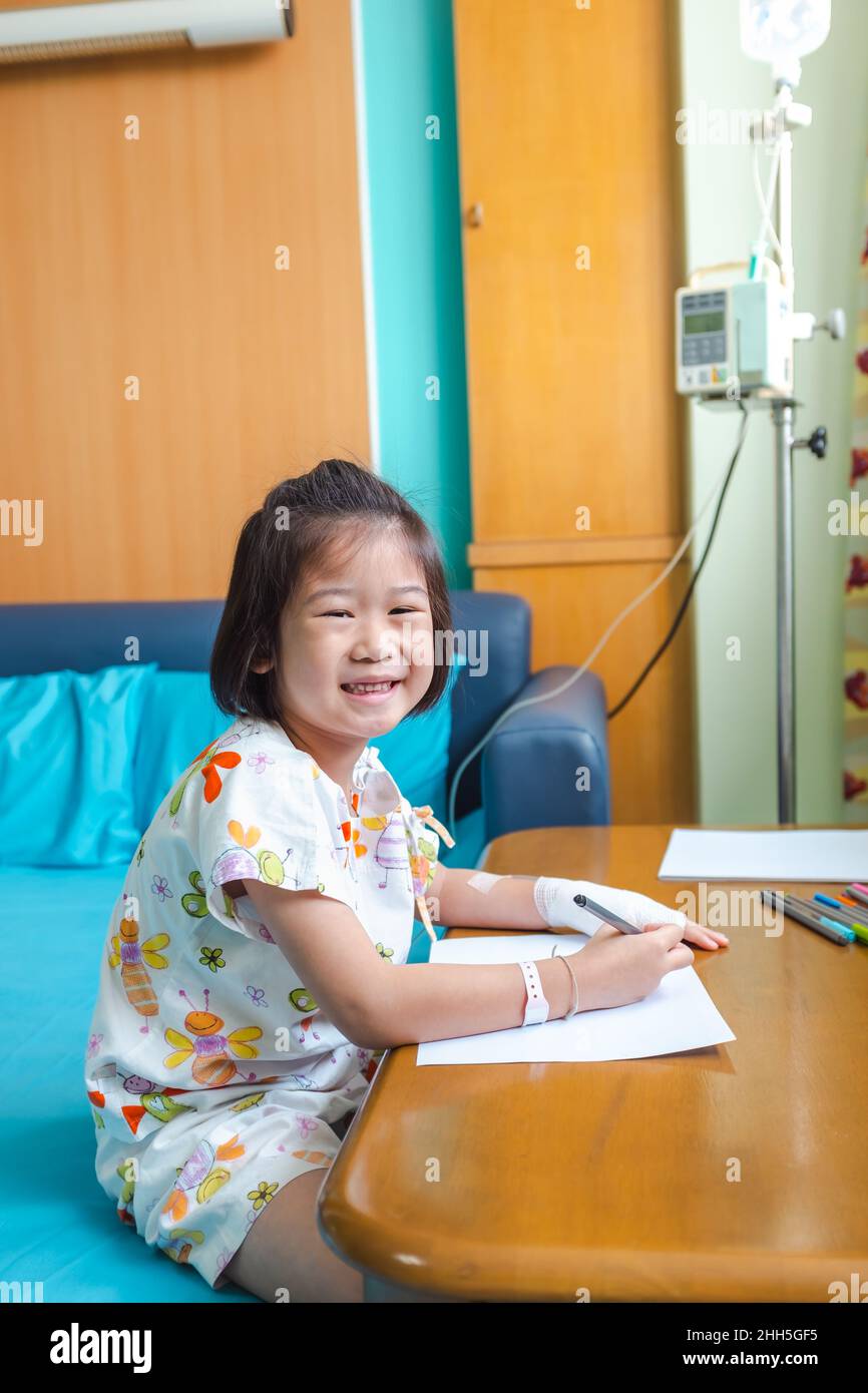 Illness girl admitted in hospital while saline intravenous (IV) on hand ...