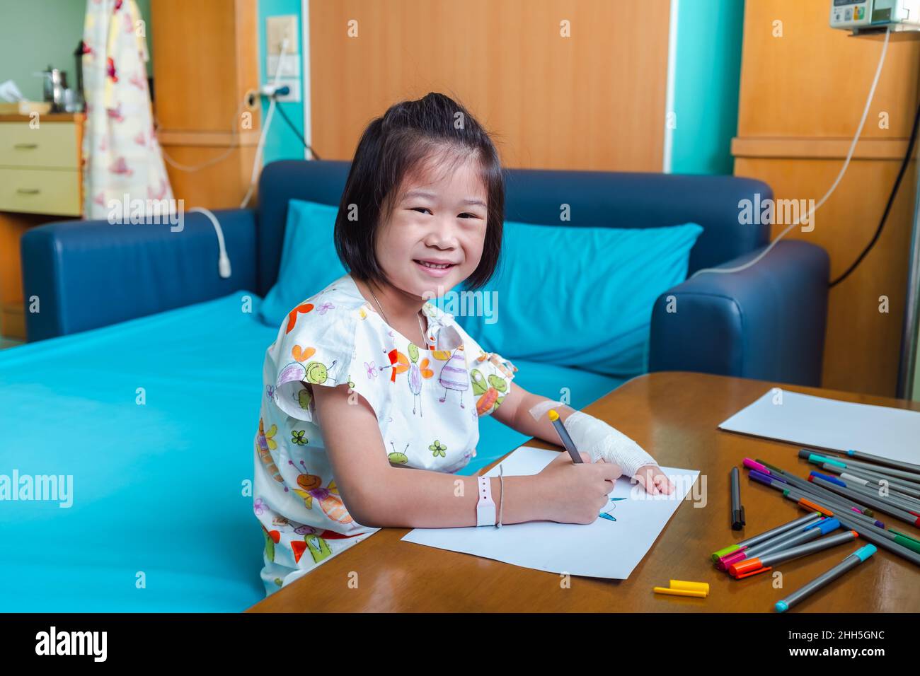 Illness girl admitted in hospital while saline intravenous (IV) on hand ...