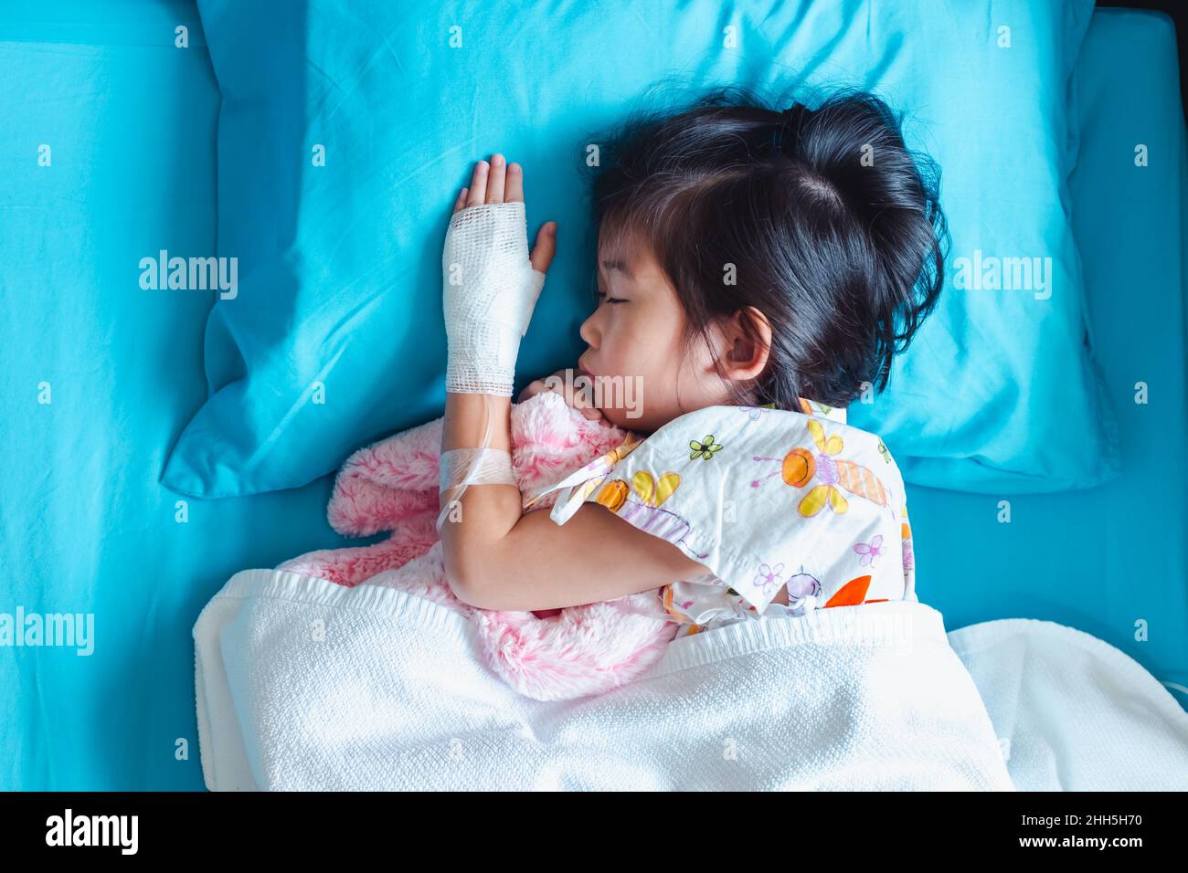 Top view. Illness asian child admitted in hospital with saline ...