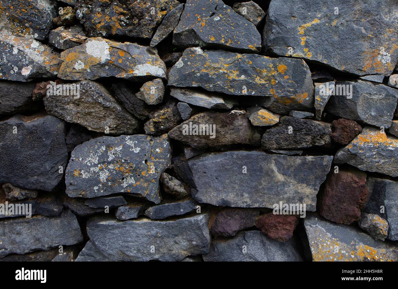 Volcanic rocks stack making stone wall Stock Photo - Alamy