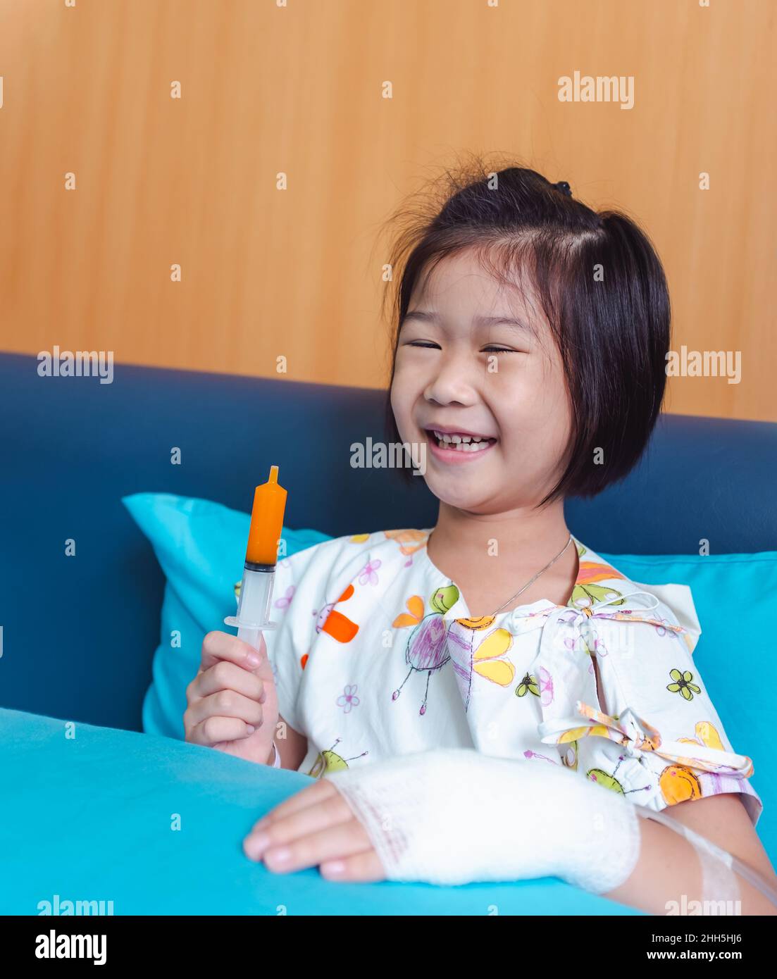 Close up of illness asian child admitted in hospital with saline ...