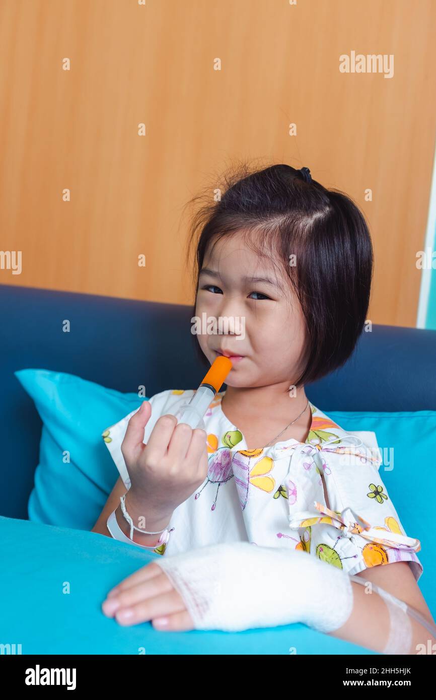 Close up of illness asian child admitted in hospital with saline ...