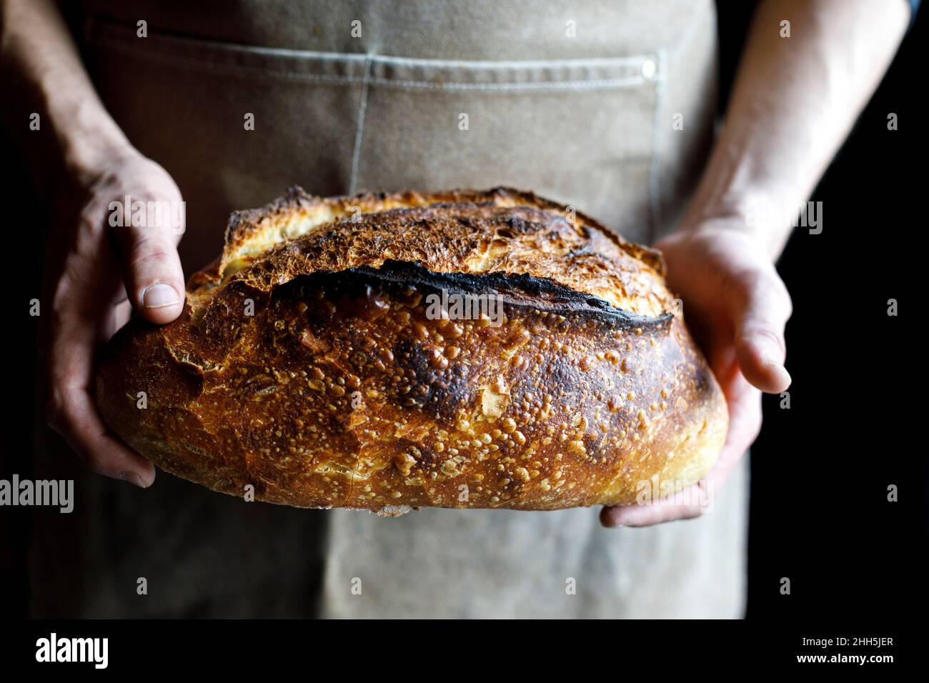 Man holding bread roll hi-res stock photography and images - Alamy