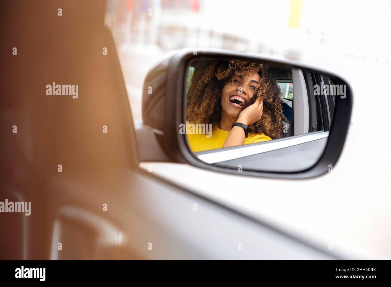 Reflection of woman in side-view mirror of car Stock Photo - Alamy
