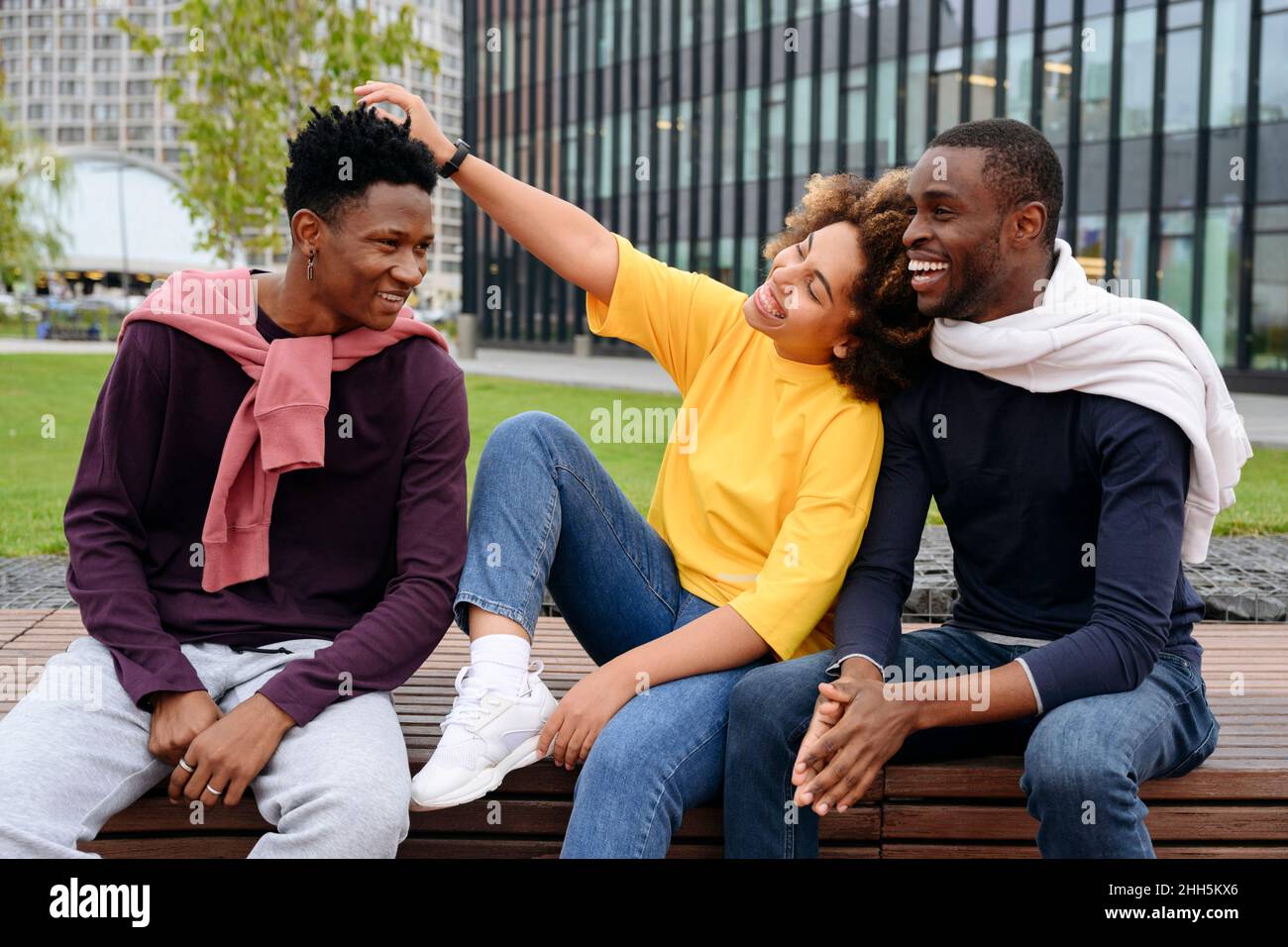 Laughing male friends sitting hi-res stock photography and images - Alamy