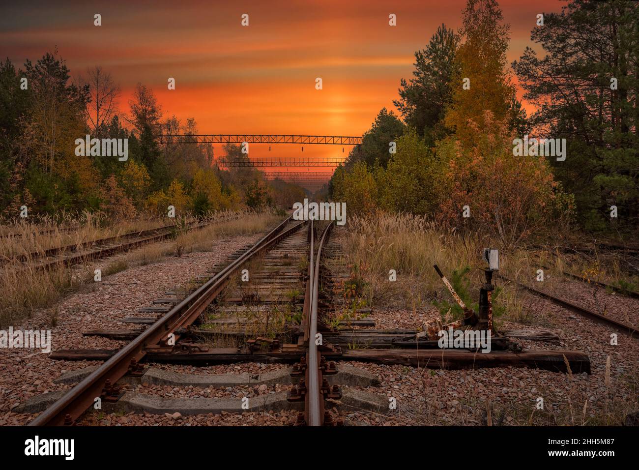 Ukraine, Kyiv Oblast, Chernobyl, Abandoned railroad tracks at fiery ...
