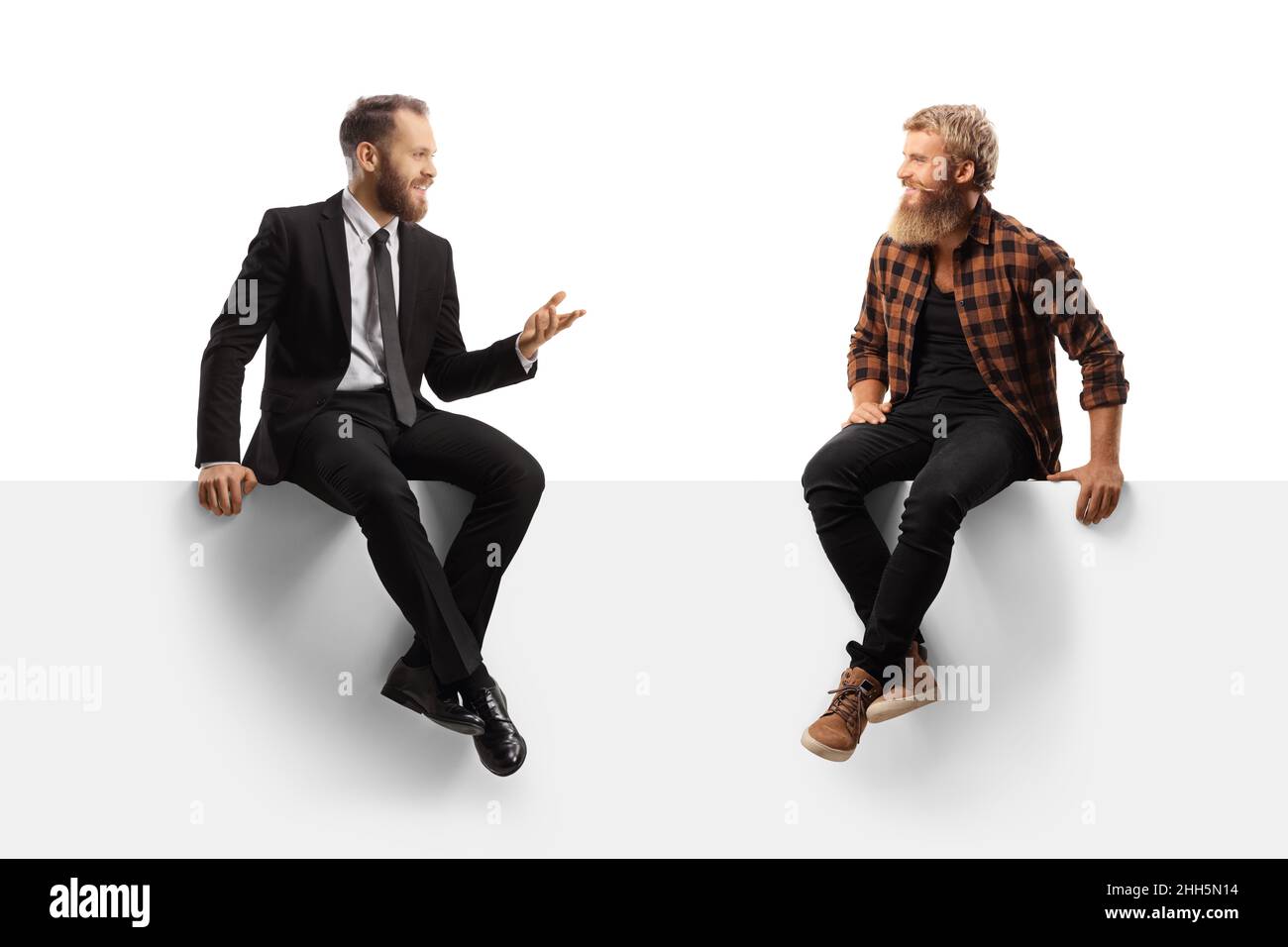 Casual man and a businessman having a conversation seated on a panel ...