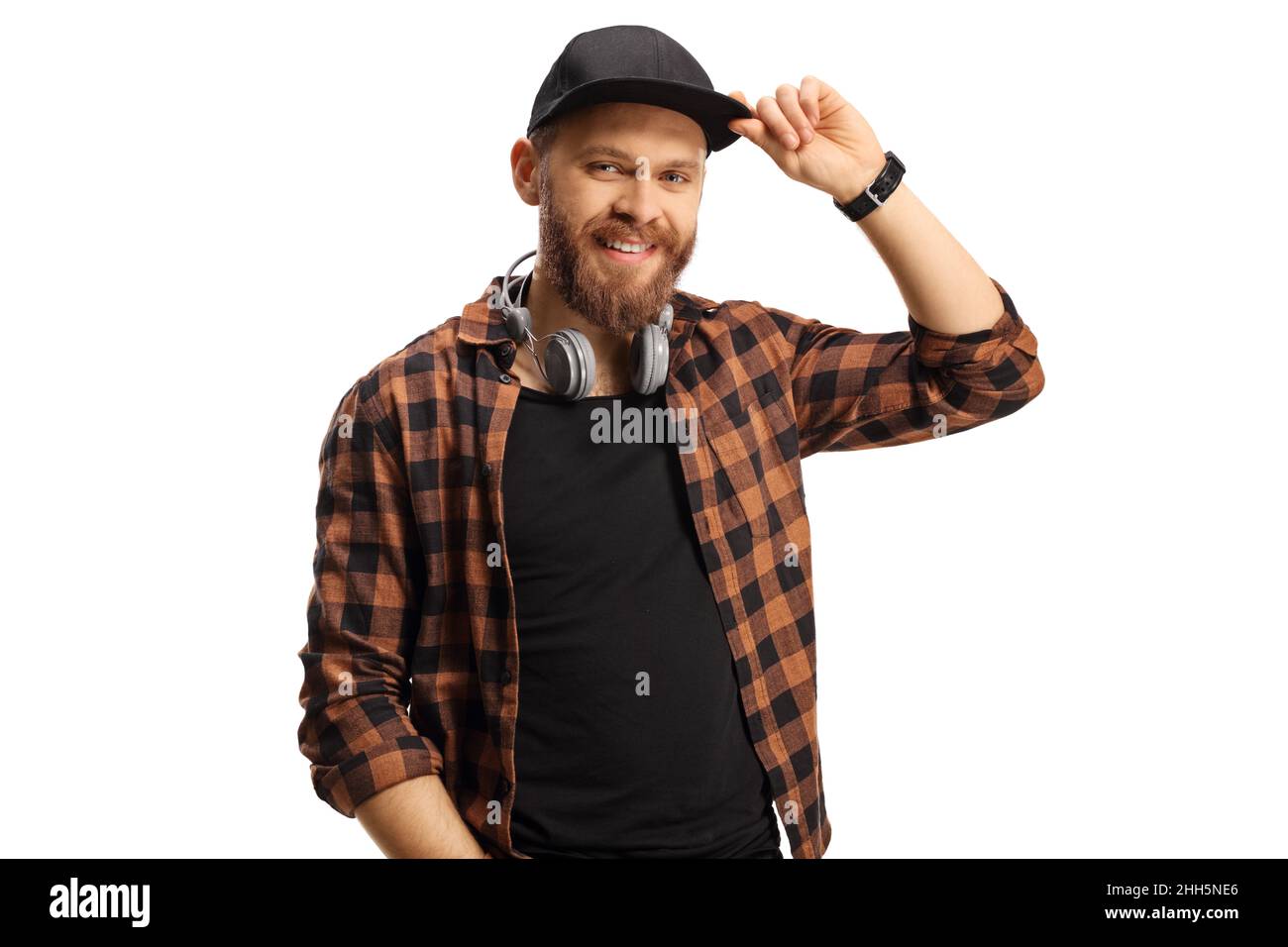 Trendy young man with headphones greeting with cap isolated on white ...