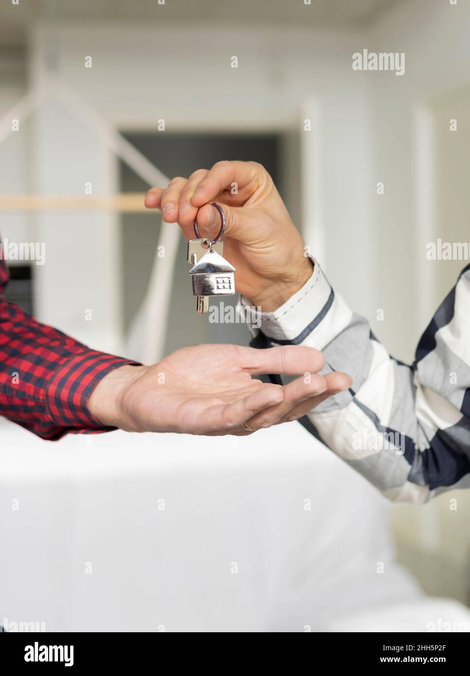 Real estate agent giving house key to customer Stock Photo - Alamy