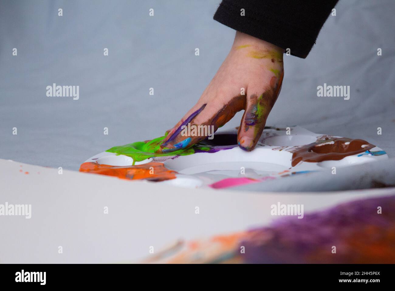 finger painting pushing paint around fun colorful Stock Photo - Alamy