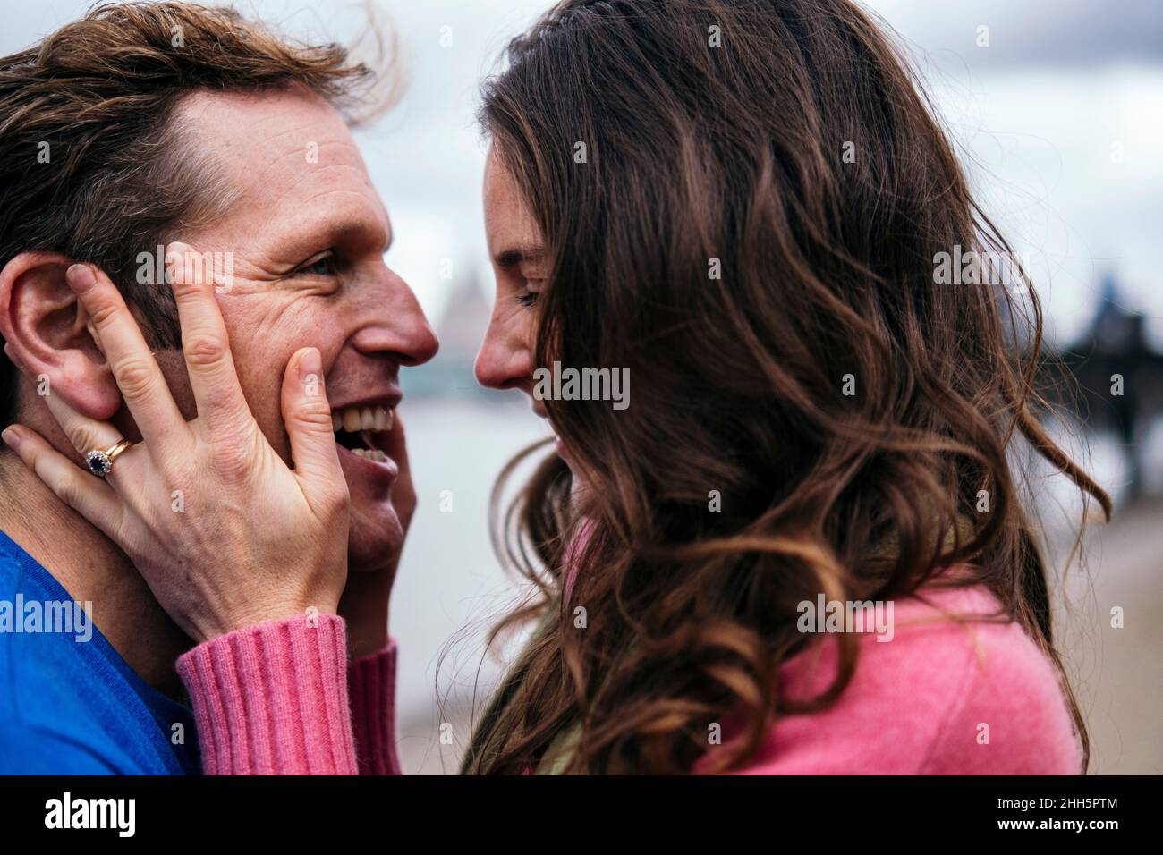 Affectionate couple with face to face laughing together Stock Photo - Alamy