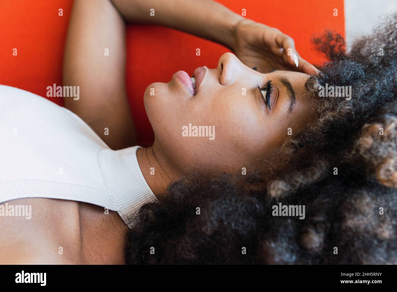 Thoughtful woman resting on sofa Stock Photo - Alamy