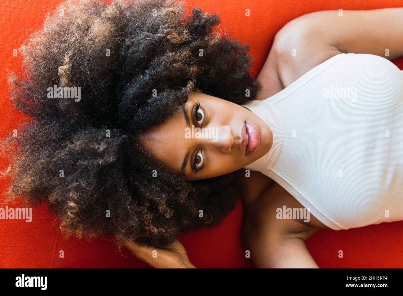 Young woman lying on back at home Stock Photo - Alamy