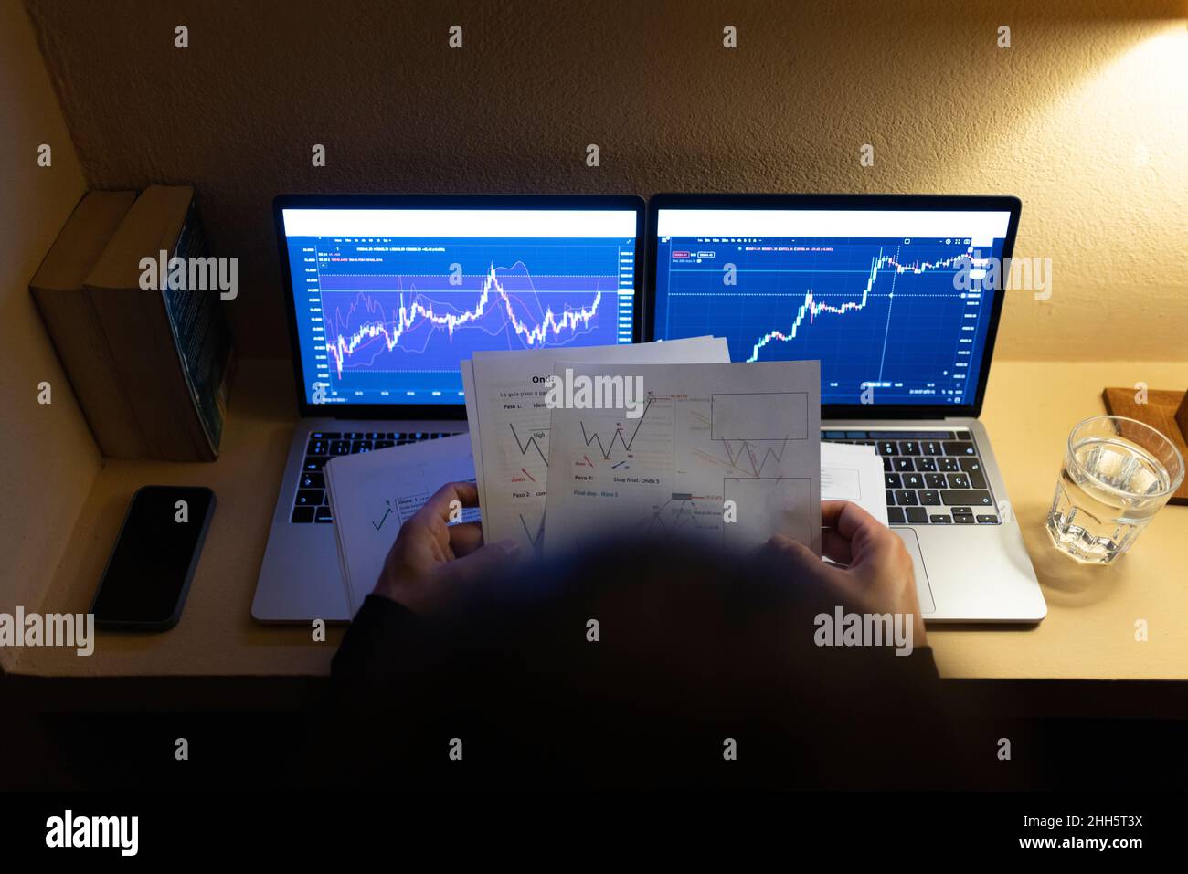 Businessman examining stock market data at home office Stock Photo - Alamy