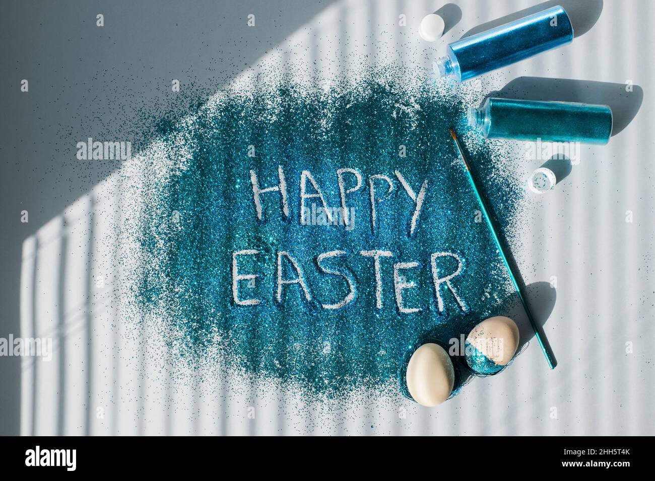 Happy Easter written in turquoise colored glitter Stock Photo - Alamy
