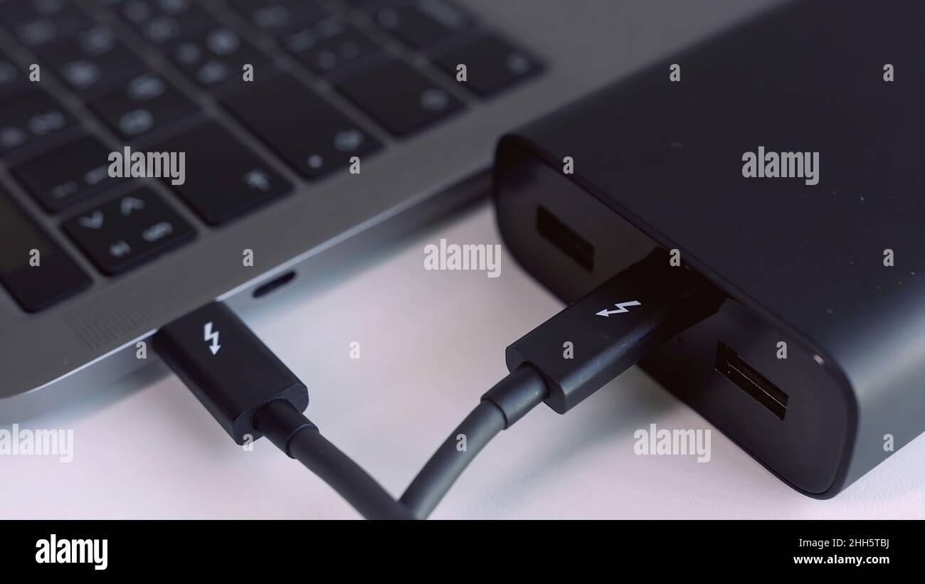 Close up of external hard drive connected to laptop. Black hard disc ...