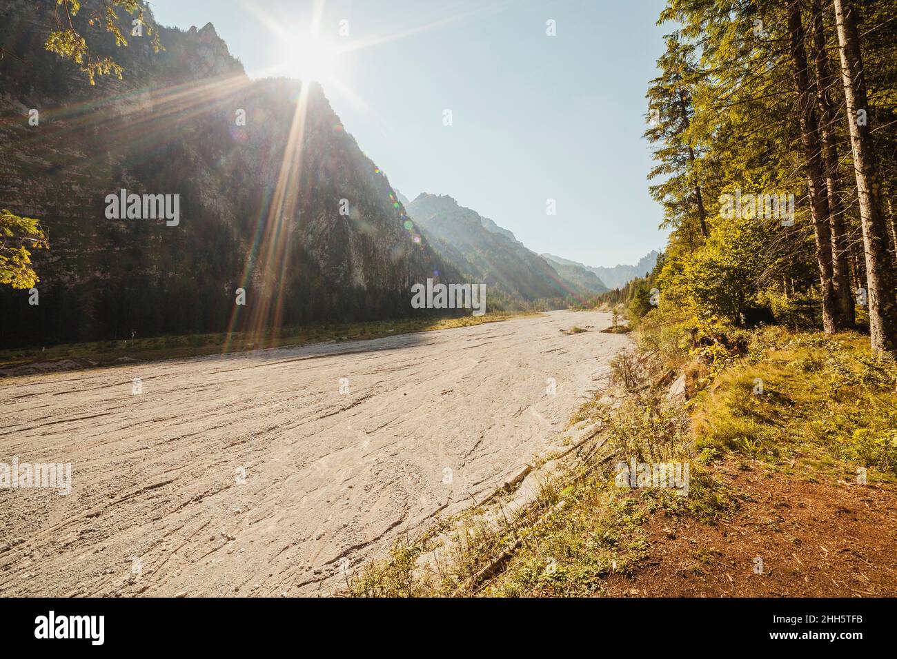 Sun shining over mountain valley Stock Photo - Alamy