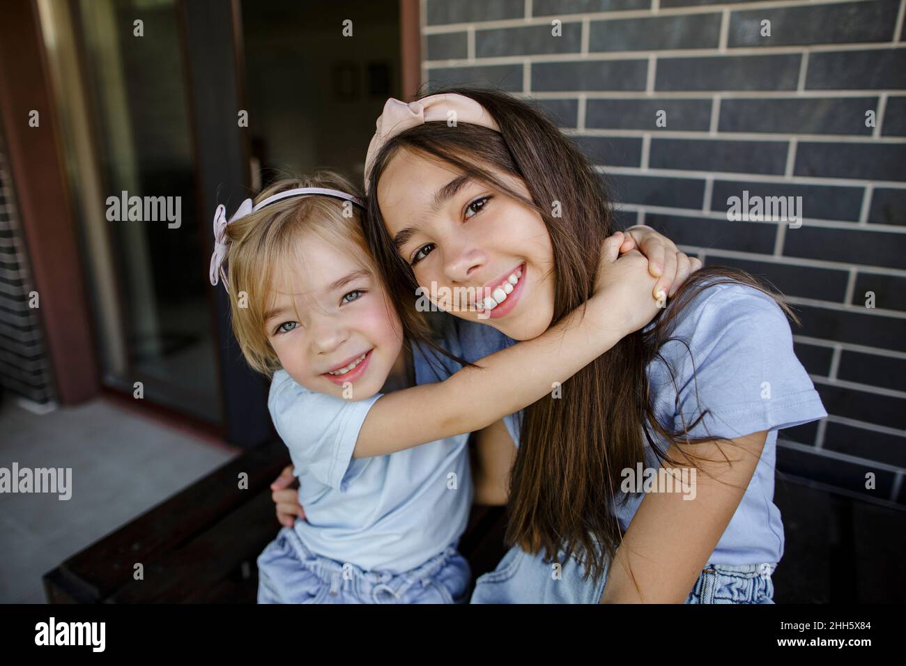 Happy siblings embracing each other Stock Photo - Alamy