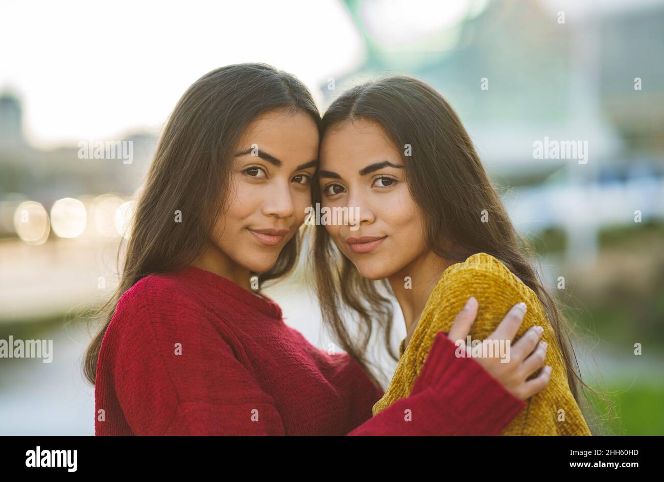 Beautiful sisters smiling and embracing Stock Photo - Alamy