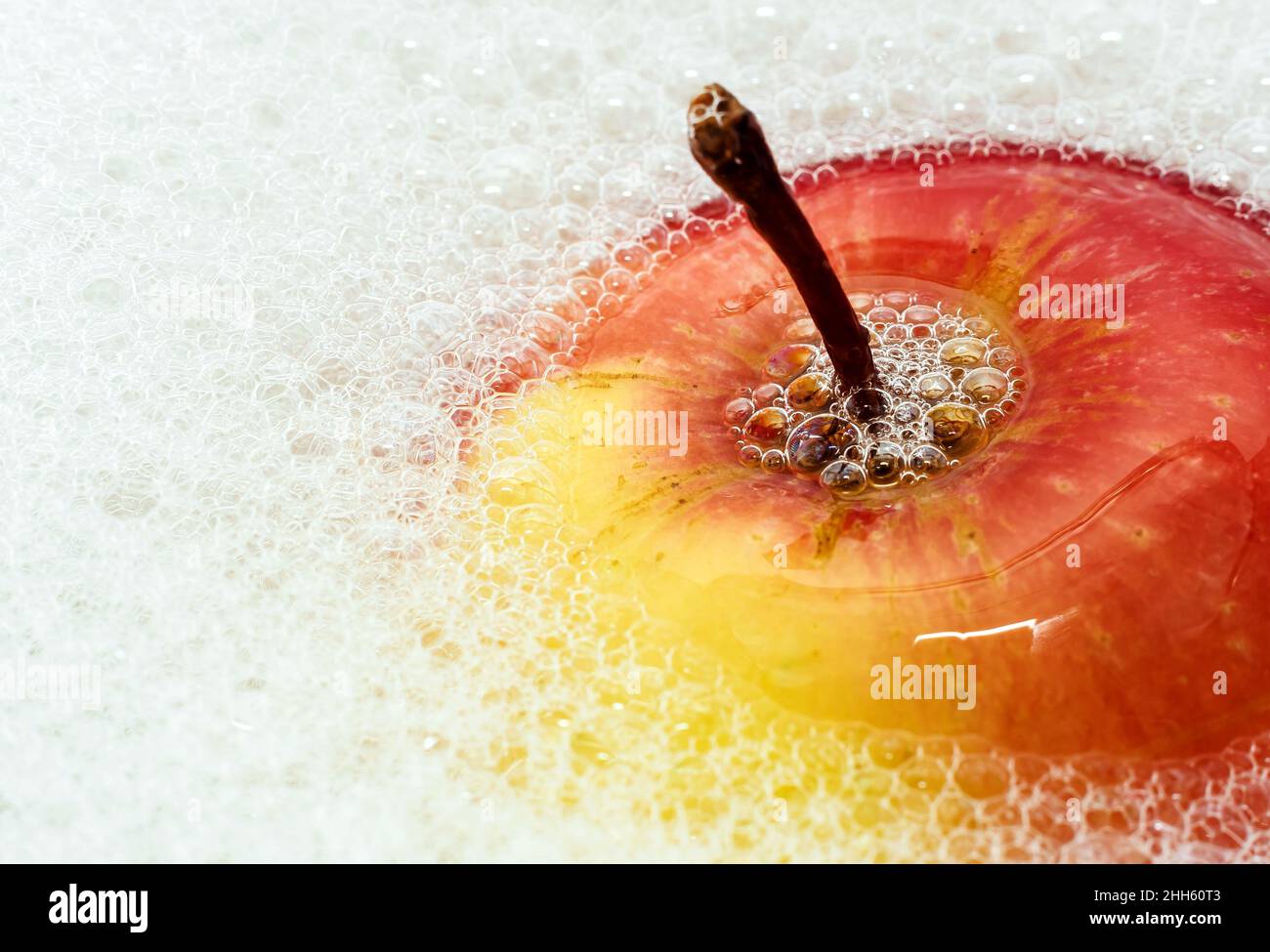 Apple in water. The apple is washed and cleaned of dirt and dust in a ...