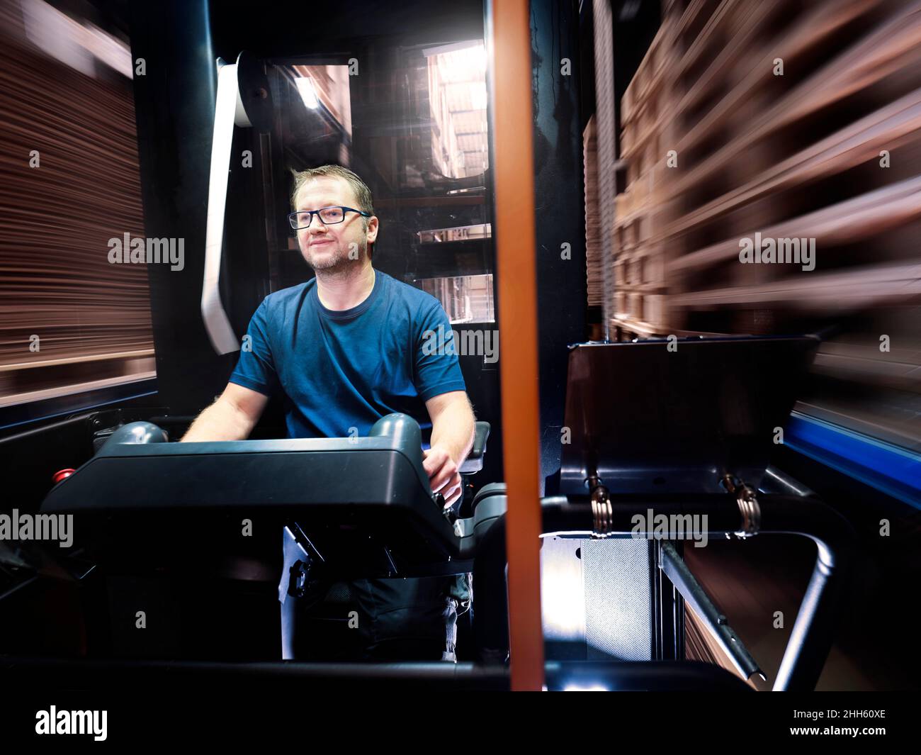 Worker using computer in automated factory Stock Photo - Alamy