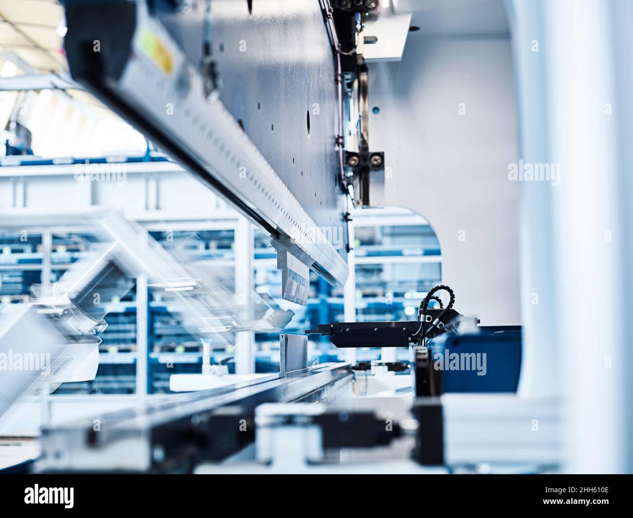 Robotic arm and bending machine in production at factory Stock Photo ...