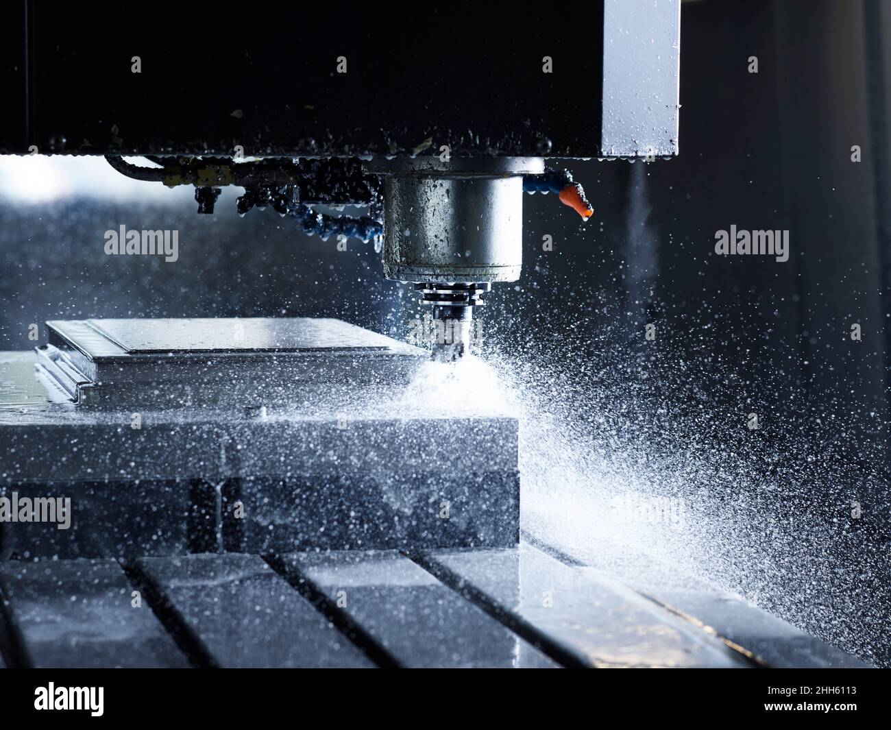 Water splashing in automated CNC machine at factory Stock Photo - Alamy